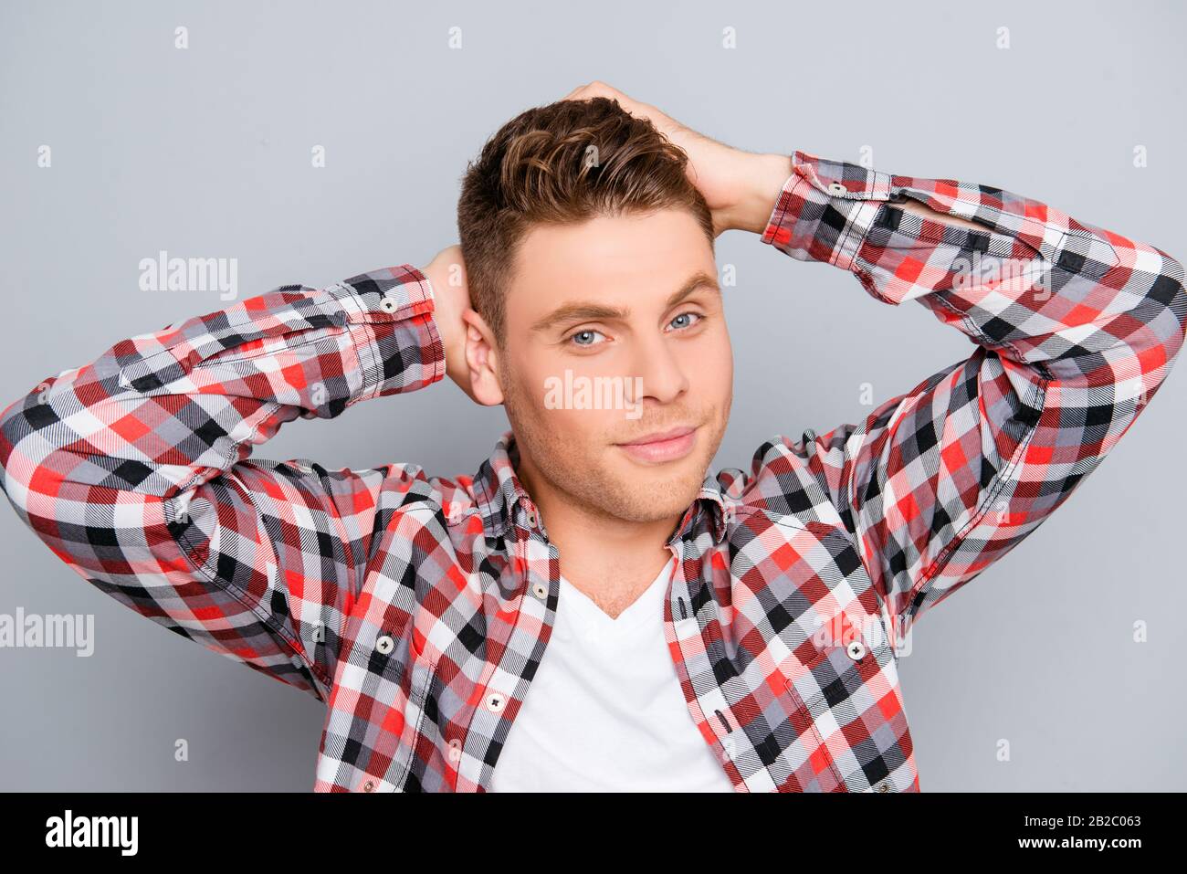 Portrait of handsome guy combing his hair with fingers Stock Photo - Alamy
