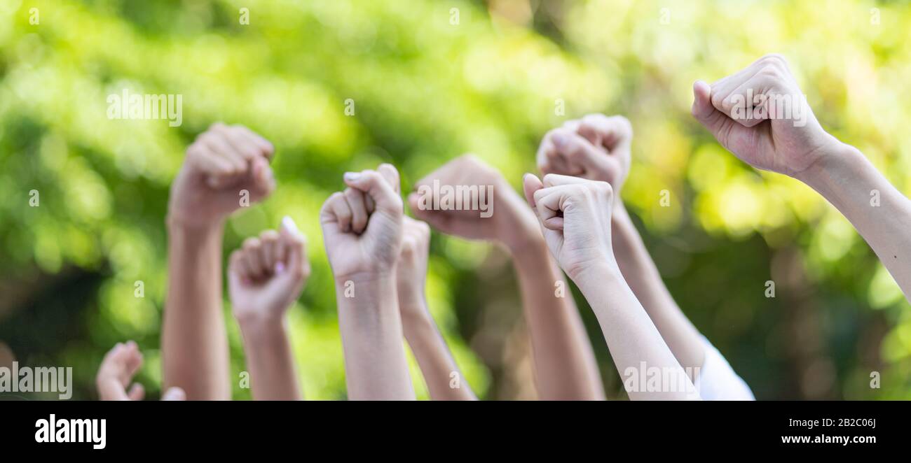 Panoramic group of hands business team raised fist air corporate ...