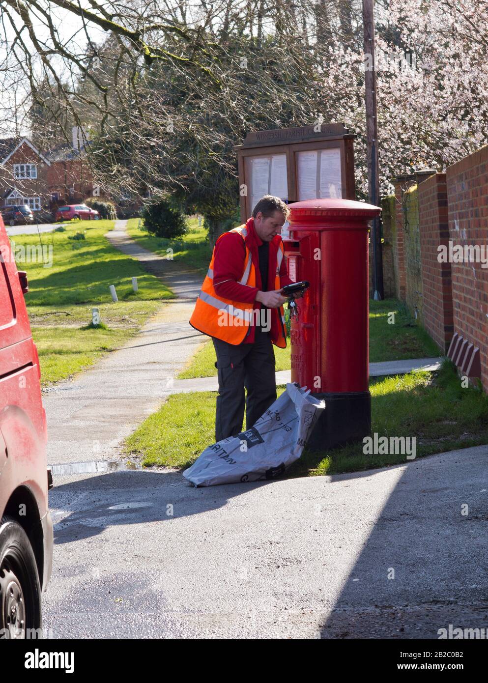 Postman collecting Royal Mail Stock Photo - Alamy