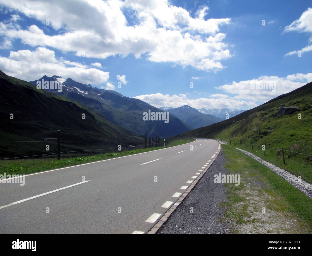 The perfect road to the mountains in the Alps Stock Photo - Alamy