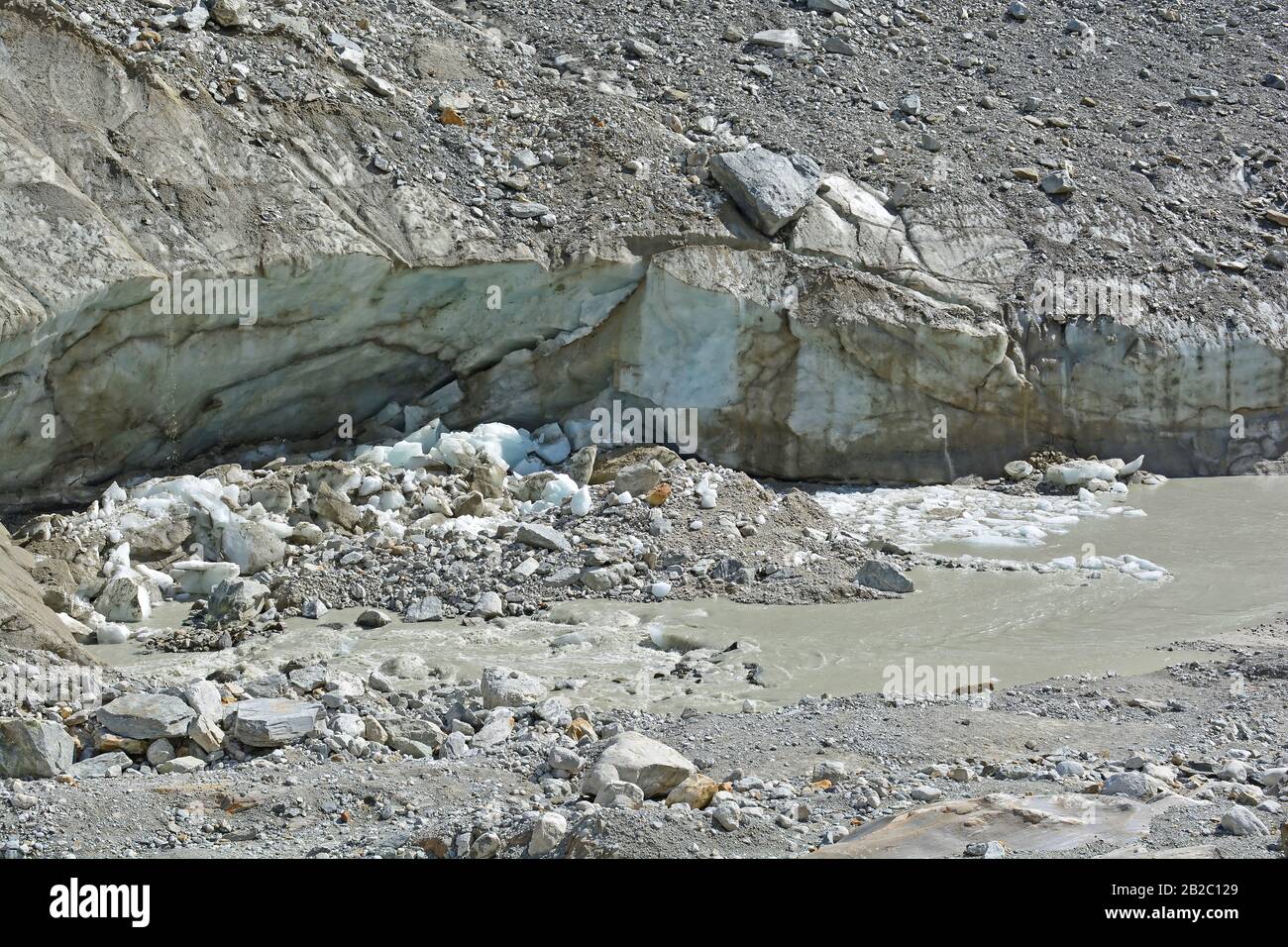 Collapsing ice cave in a glacier dug out by a meltwater river and ...