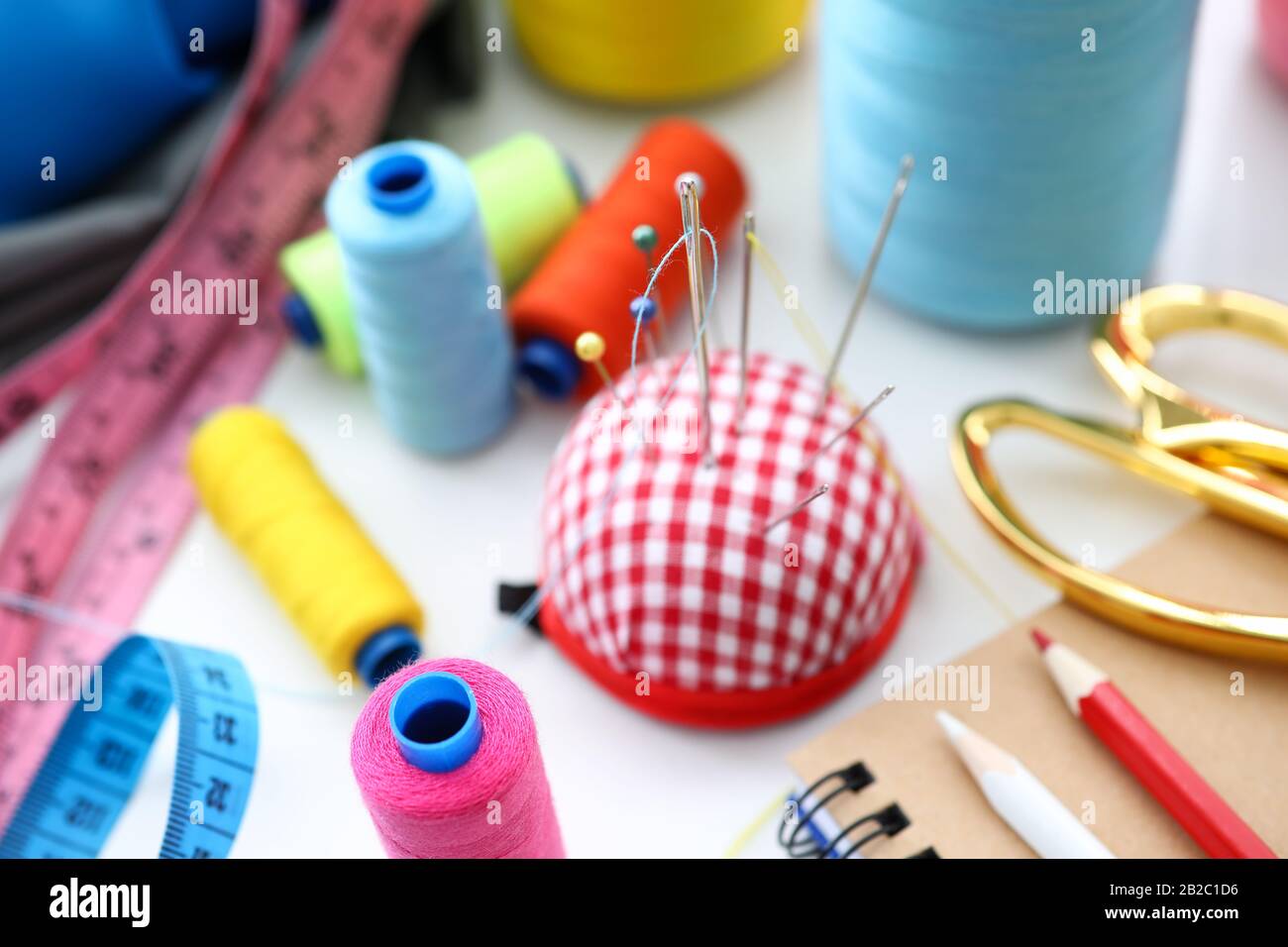 Set of threads and needles ready to be used Stock Photo - Alamy