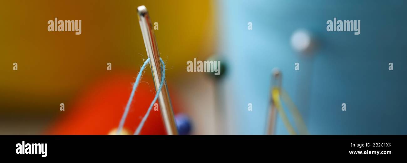 Needle eye with piece of blue thread stick out of pincushion Stock ...