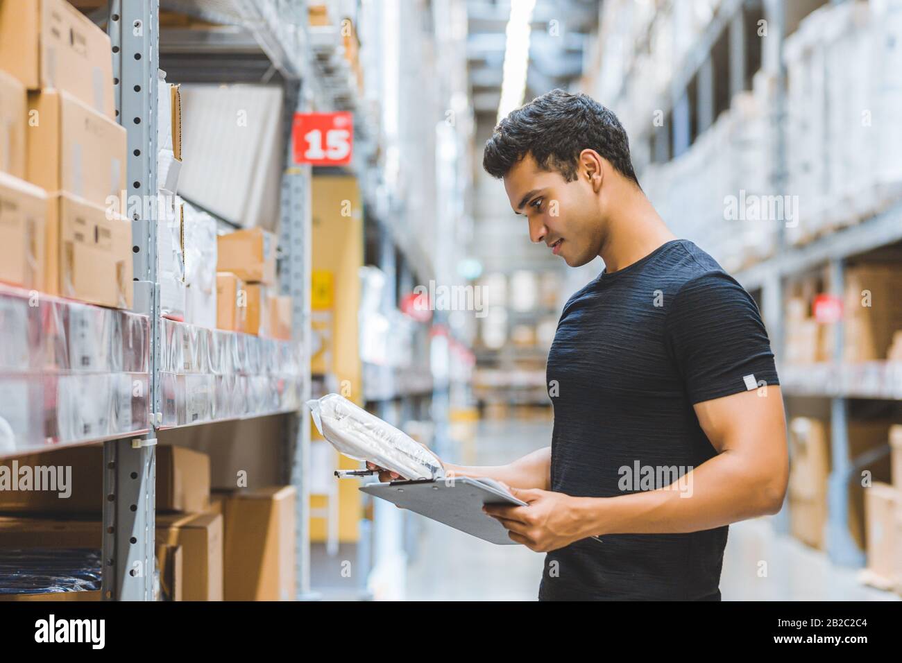 Smart Indian engineer man worker doing stocktaking of product ...