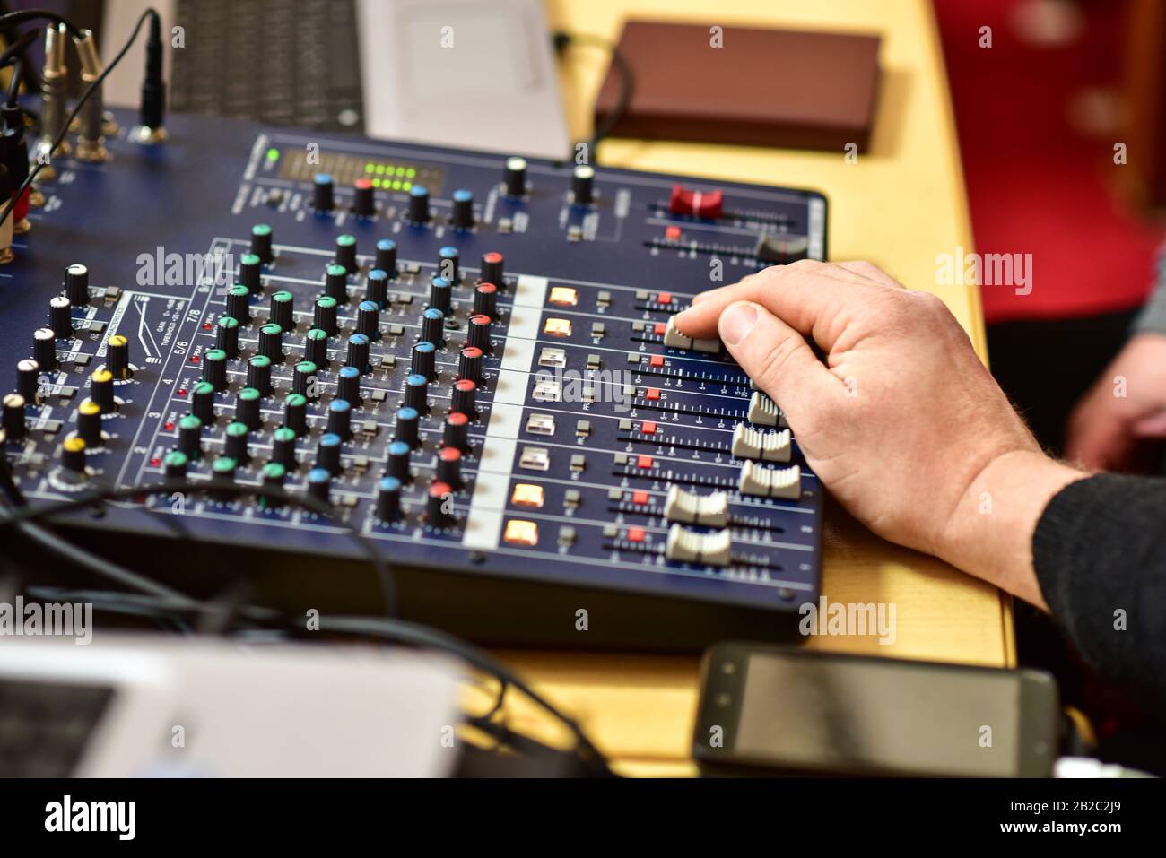 Human hand controls music mixer panel Stock Photo - Alamy