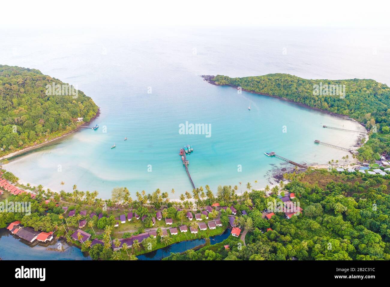 Aerial sea view of beautiful curve beach with wooden pier blue ocean ...