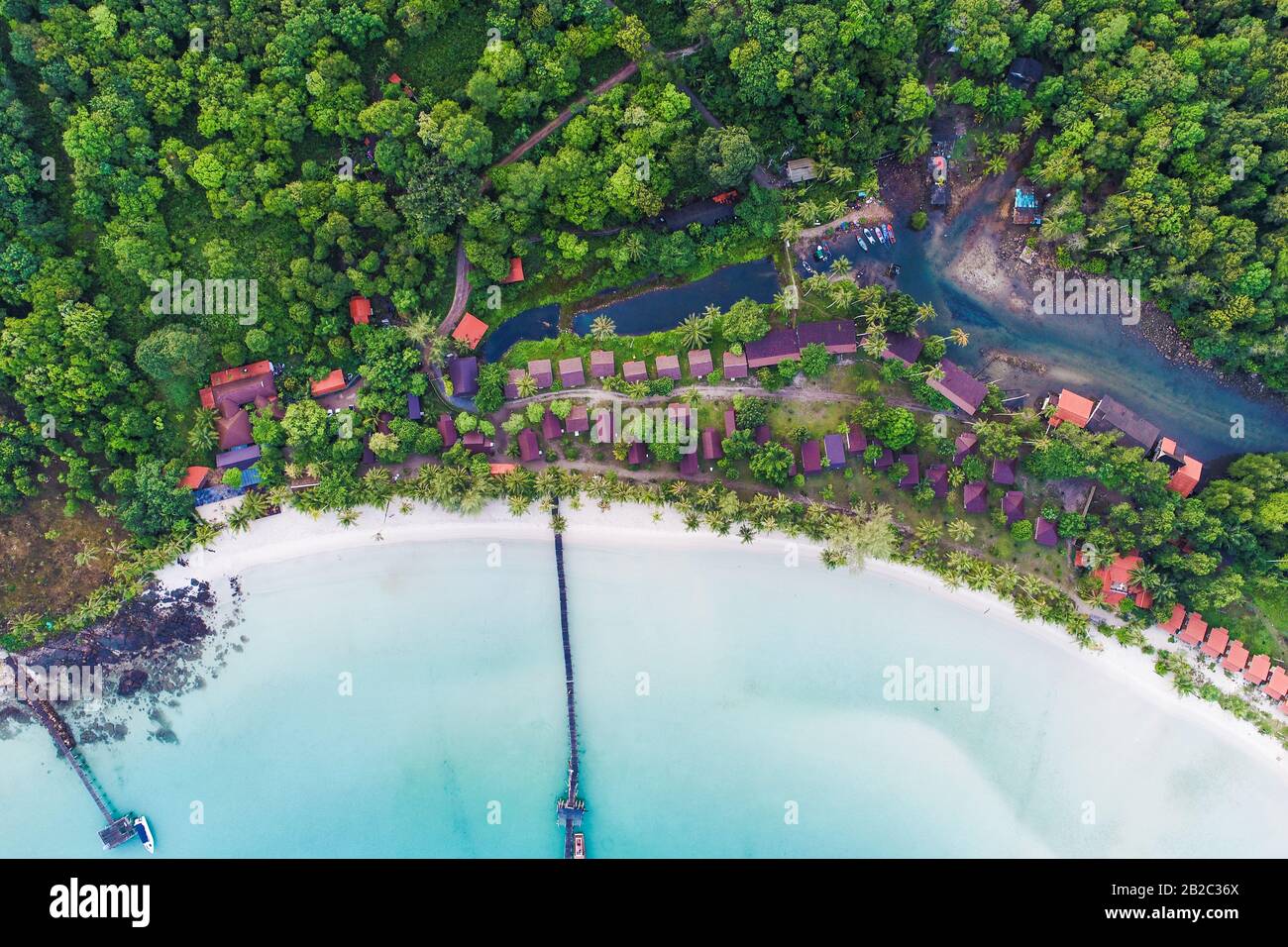 Aerial sea view of beautiful curve beach with wooden pier blue ocean ...