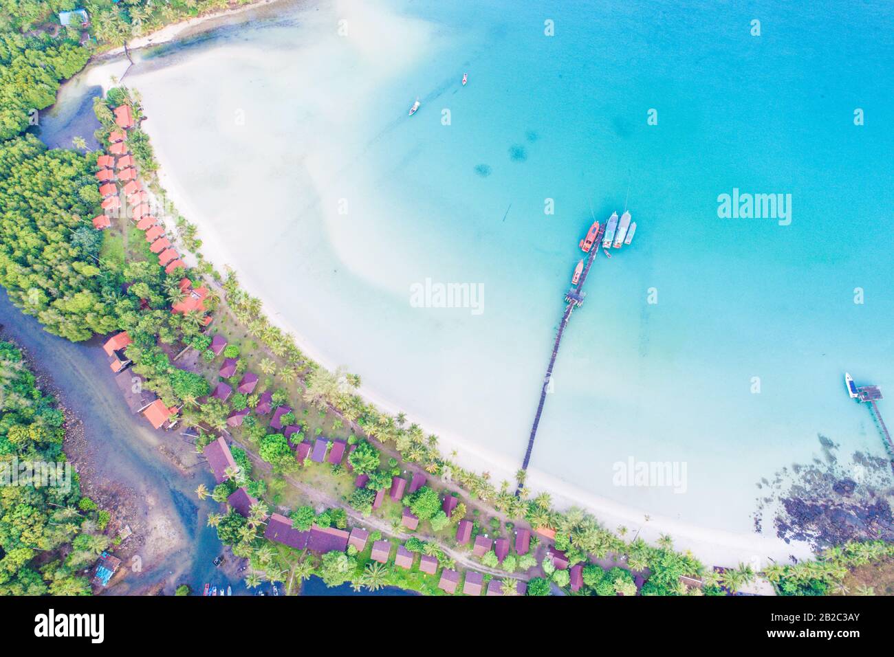 Aerial sea view of beautiful curve beach with wooden pier blue ocean ...