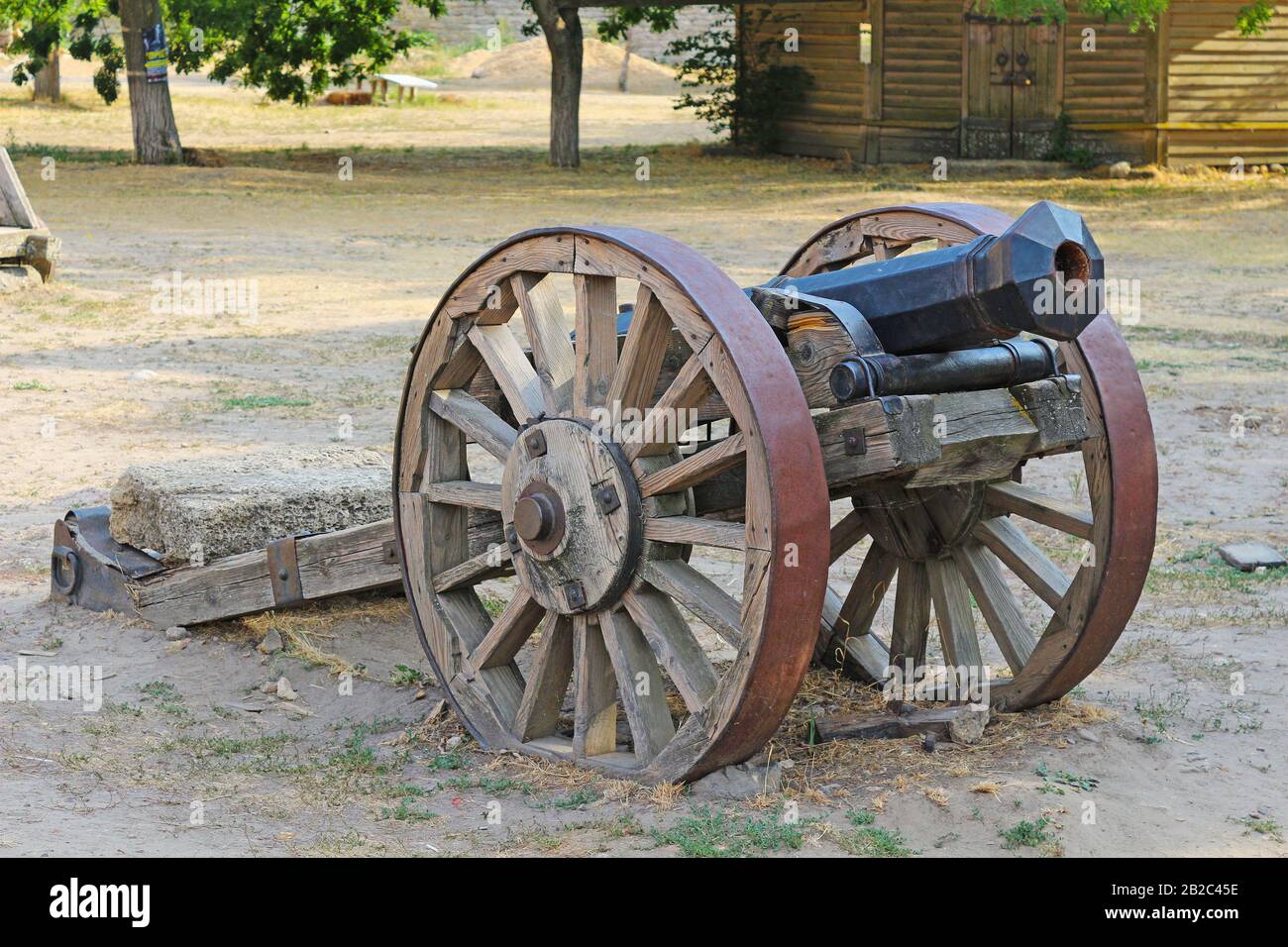 Old cannon on wheels. Military weapon Stock Photo - Alamy