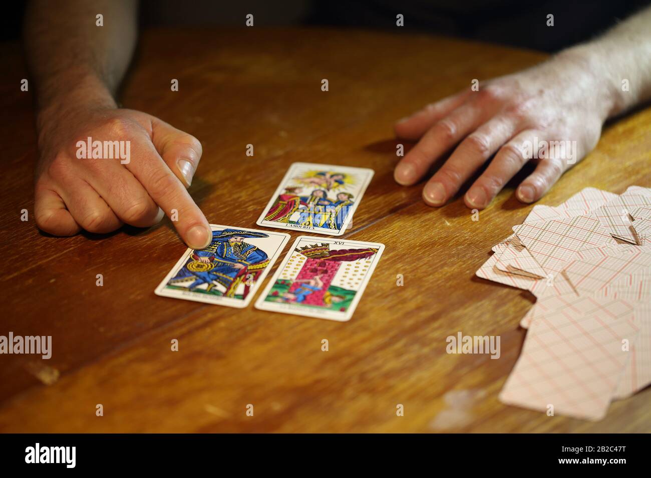 Men's hands hold tarot cards Stock Photo - Alamy