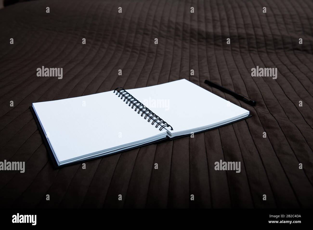open notebook to point with a pen on a textile Stock Photo - Alamy