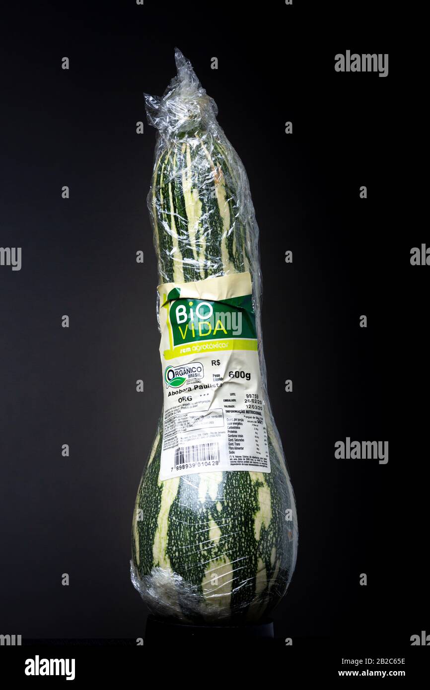 Organically grown courgette with yellow and green pattern wrapped in ...