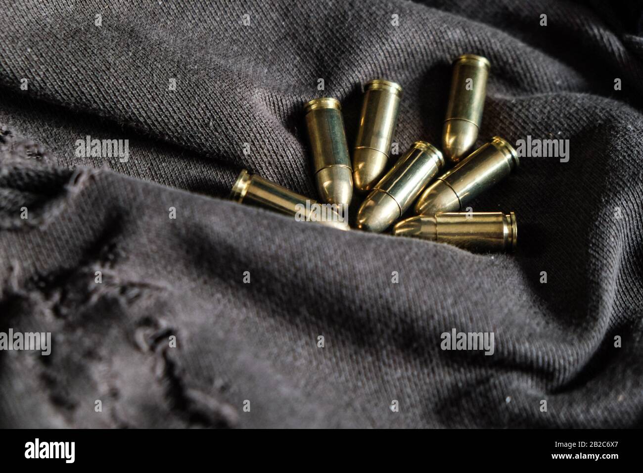 Full metal jacket 9mm ruger bullet on cloth texture arm object Stock ...