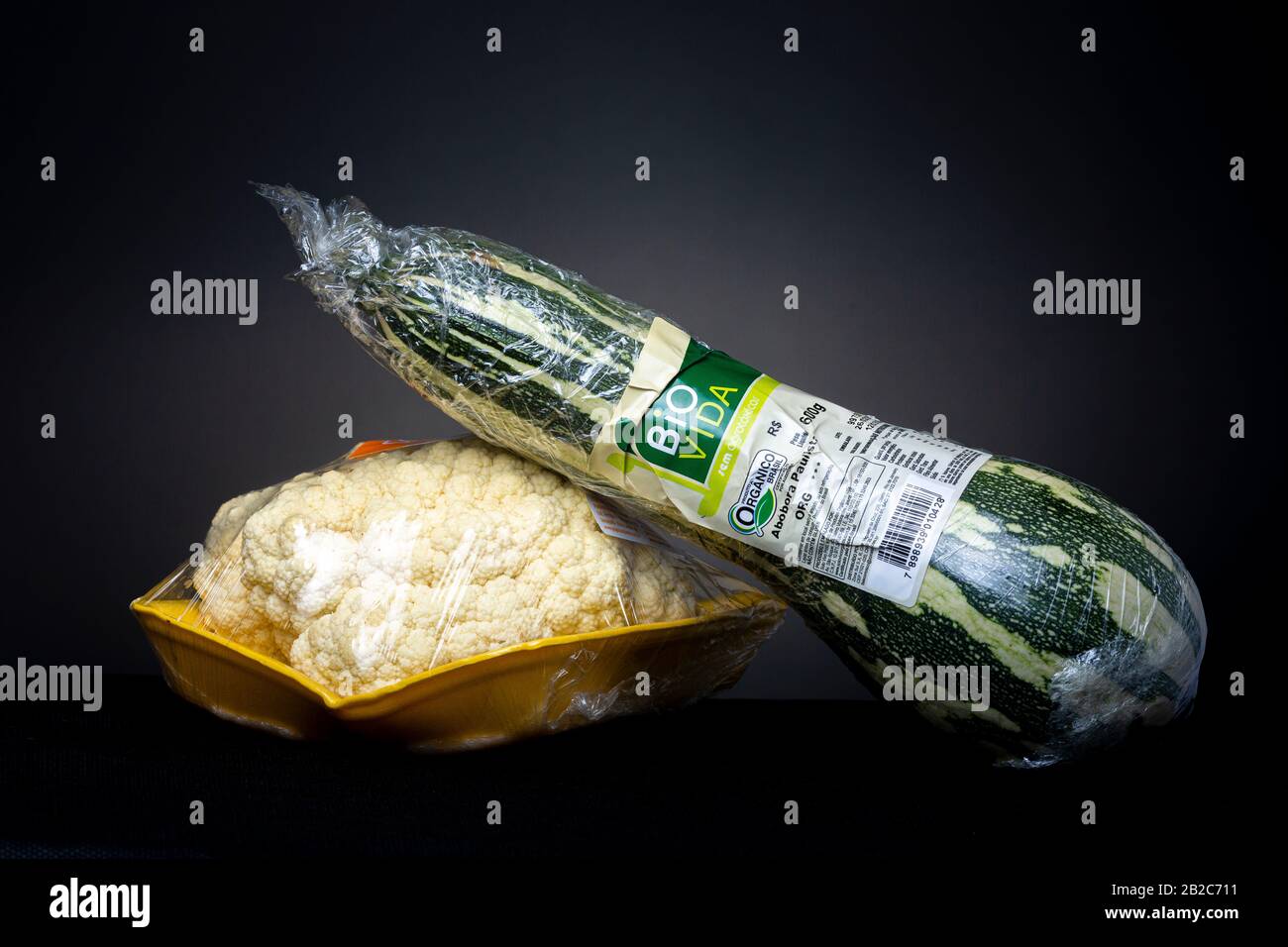 Plastic wrapped and packed cauliflower and courgette vegetables in ...