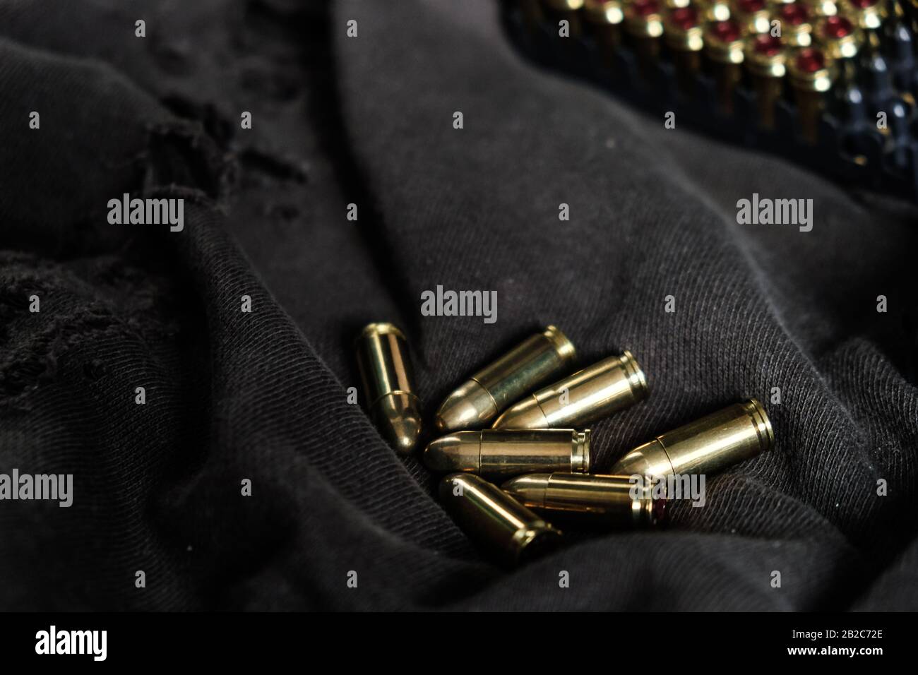 Full metal jacket 9mm ruger bullet on cloth texture arm object Stock ...