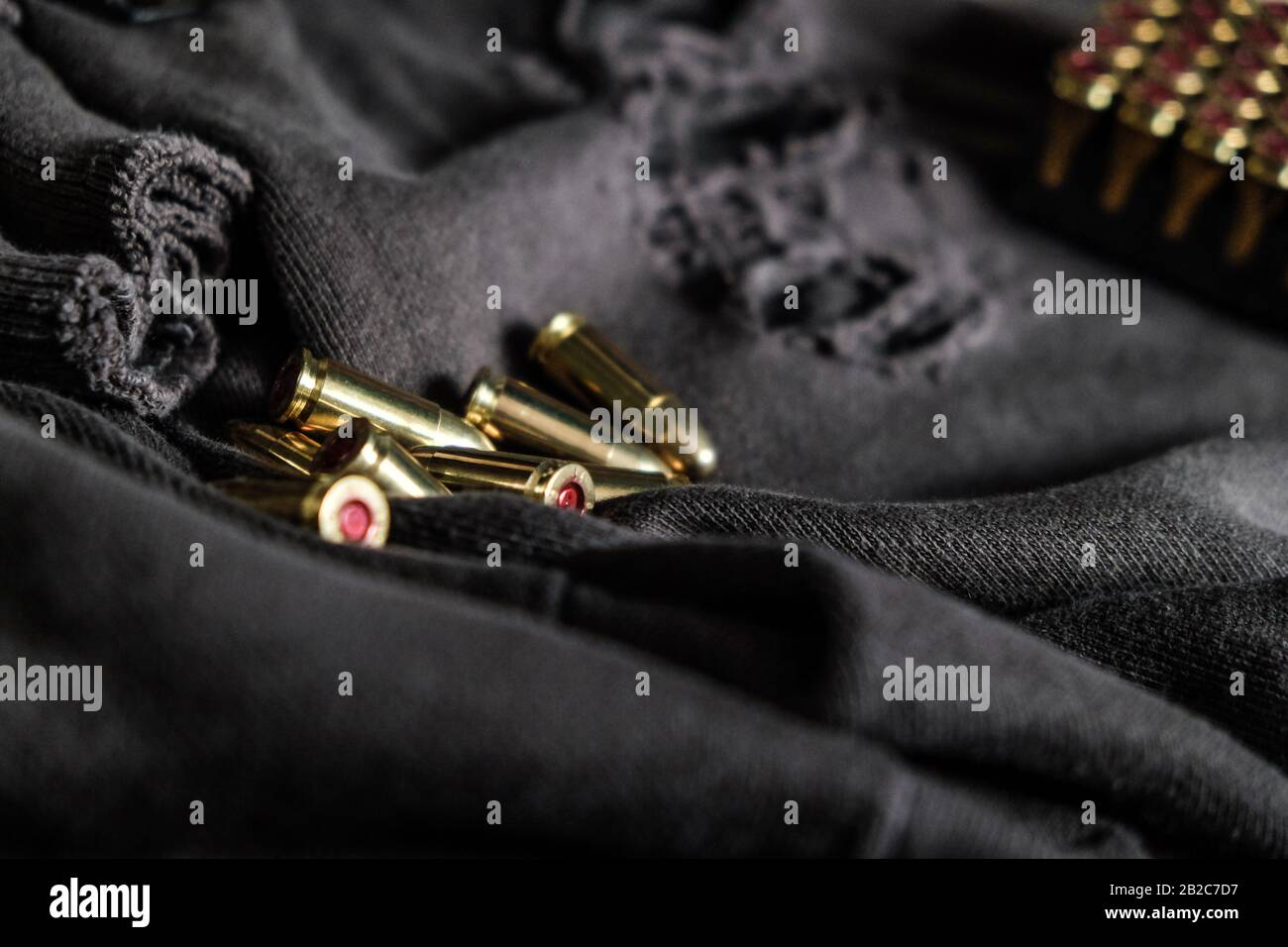 Full metal jacket 9mm ruger bullet on cloth texture arm object Stock ...