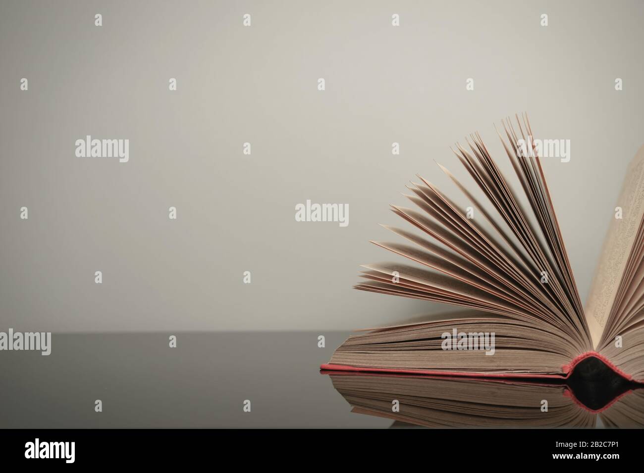 Beautiful open book on a gray and glass table background Stock Photo ...