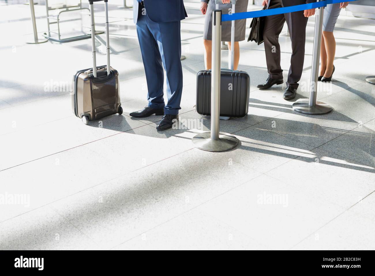 Business people queueing for check in airport Stock Photo - Alamy