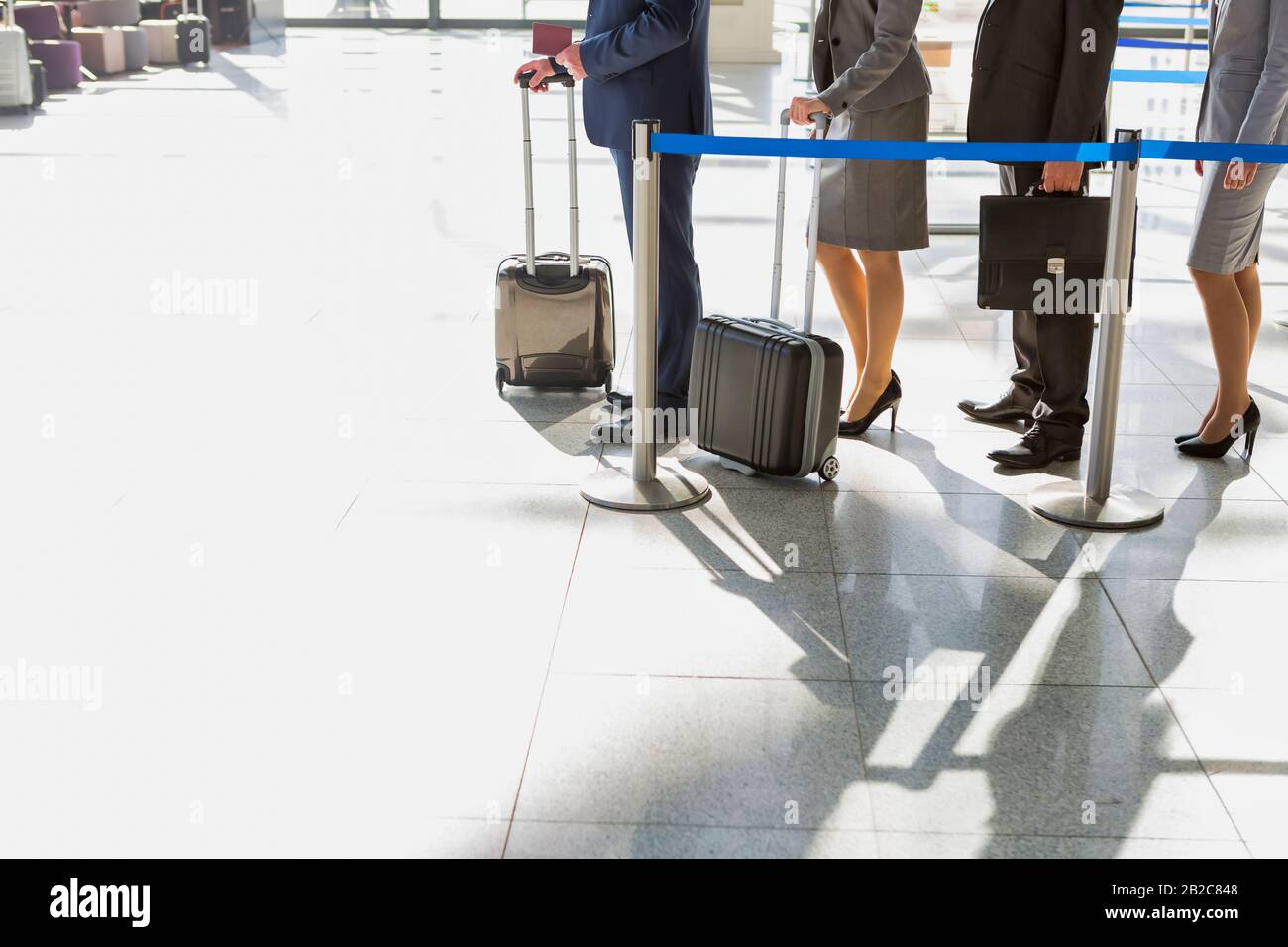 Business people queueing for check in airport Stock Photo - Alamy