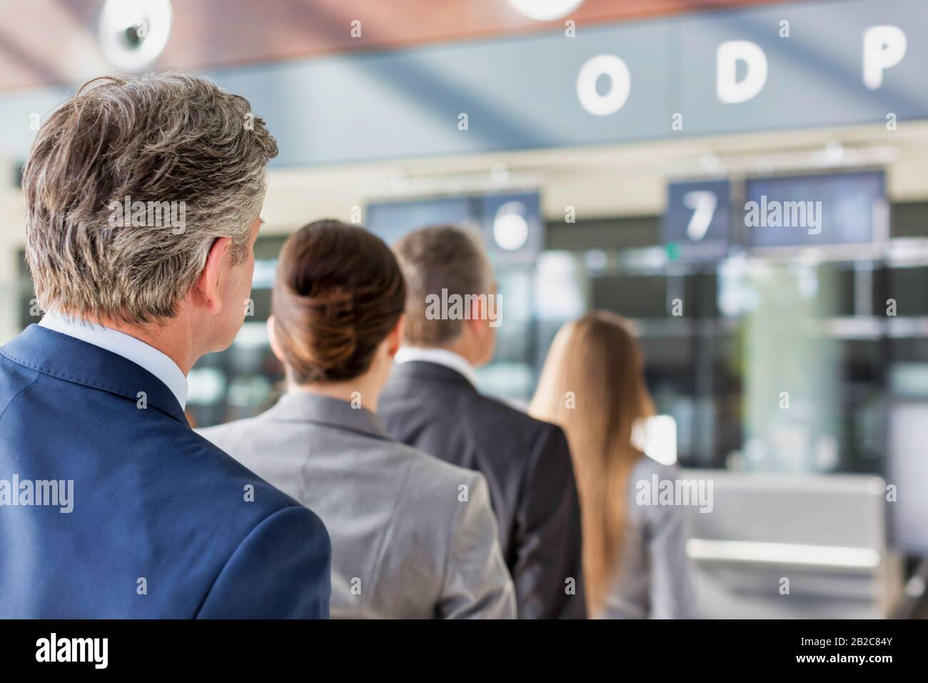 Business people queueing for check in at airport Stock Photo - Alamy