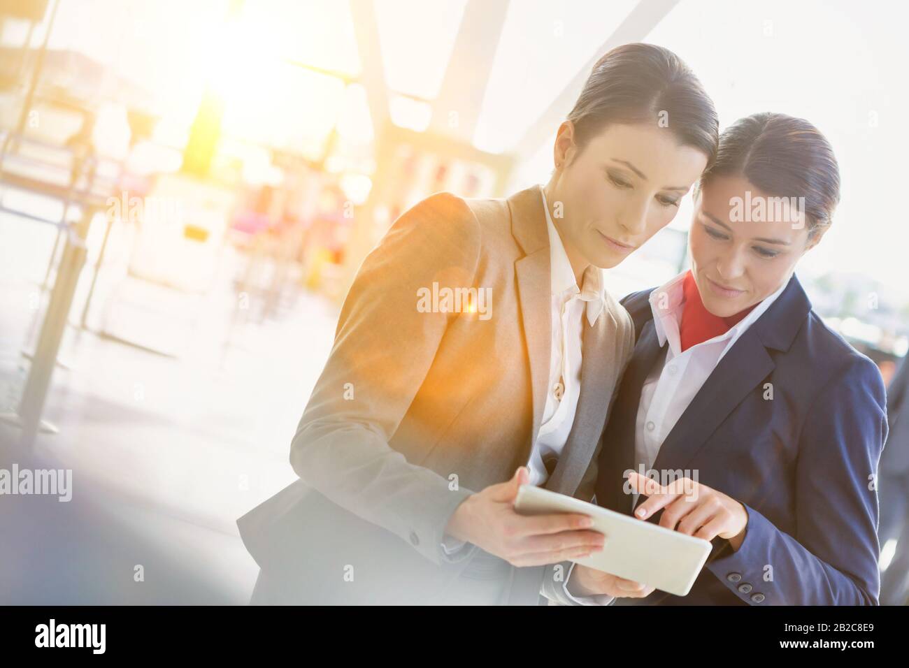 Businesswoman asking for assistance with passenger service agent in ...