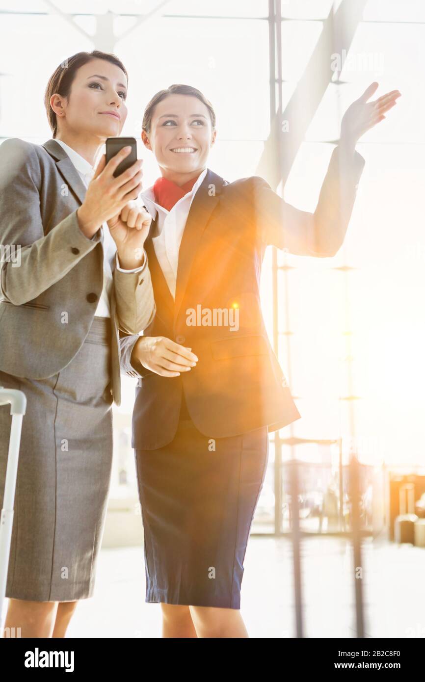 Passenger service agent assisting and giving directions with ...