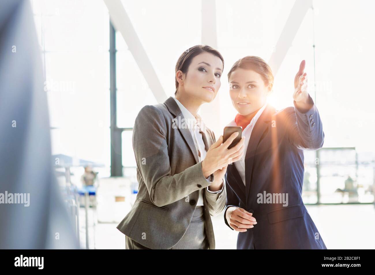 Passenger service agent assisting and giving directions with ...