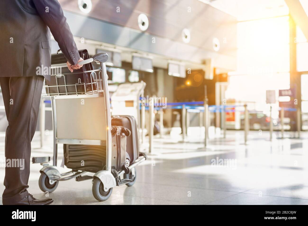 Mature businessman pushing baggage cart for check in at airport Stock ...