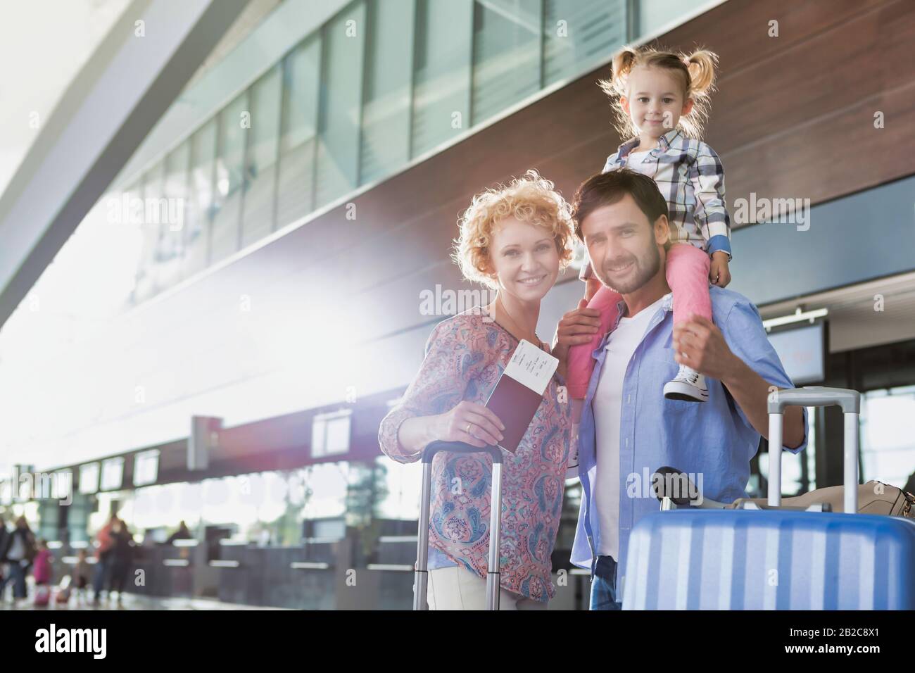 Portrait of one happy family arriving in airport with lens flare Stock ...