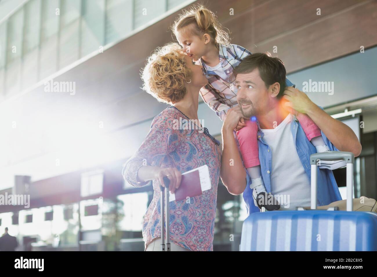 Portrait of one happy family arriving in airport with lens flare Stock ...