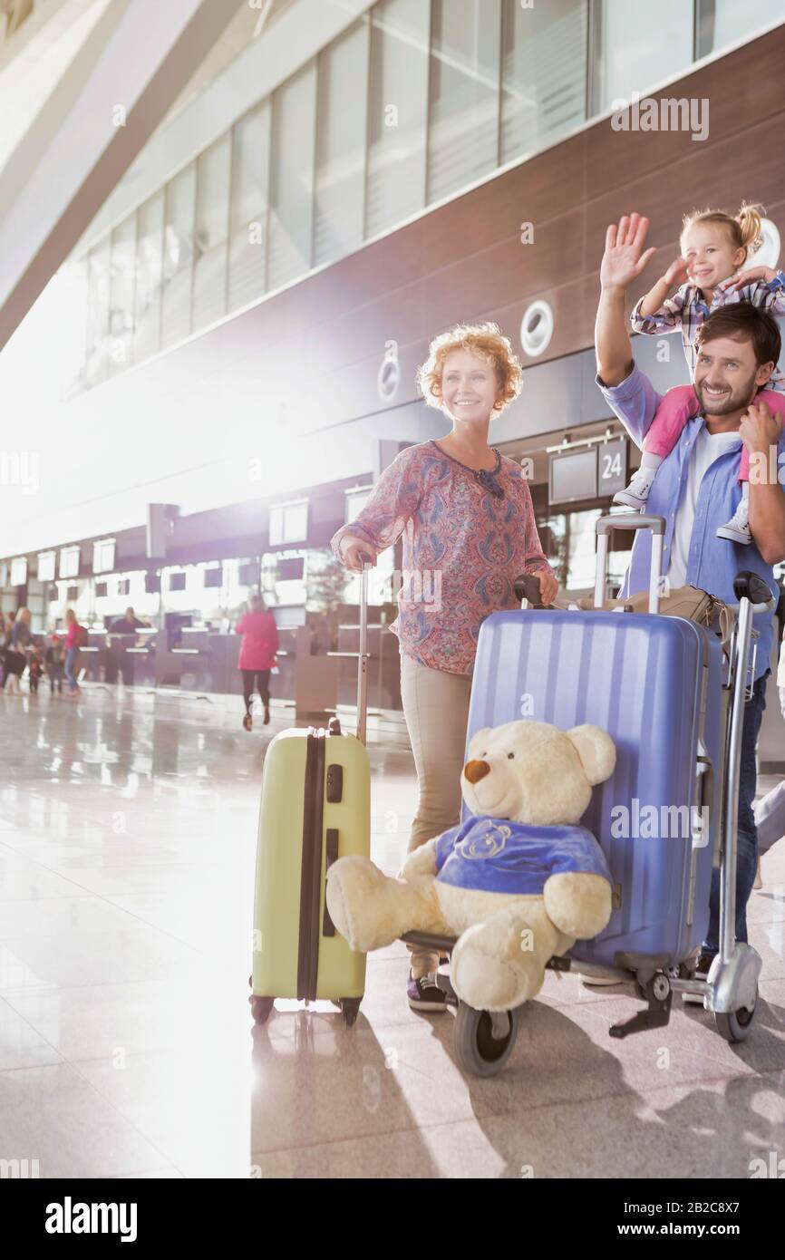 Portrait of one happy family arriving in airport with lens flare Stock ...