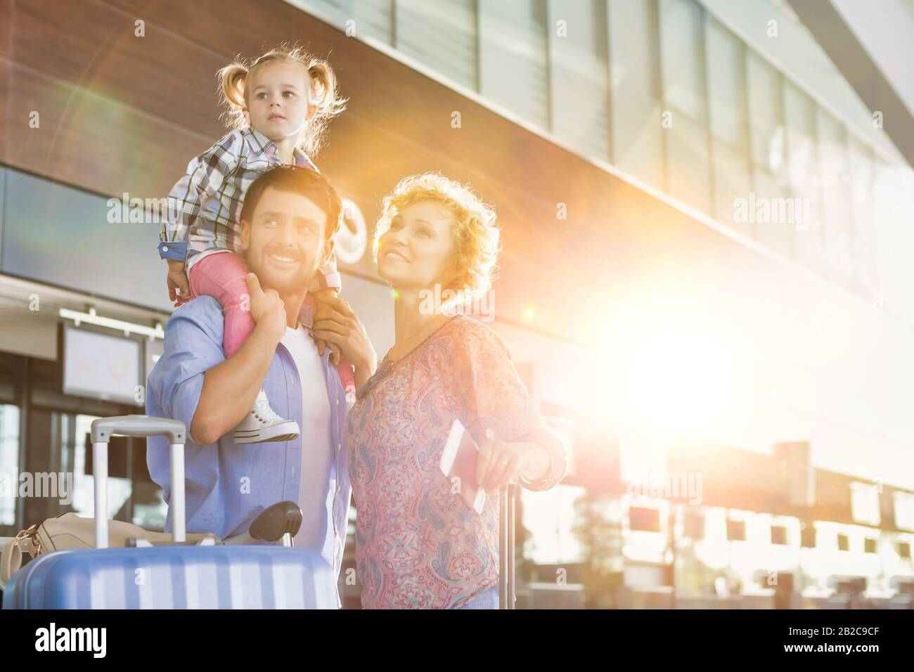 Portrait of one happy family arriving in airport with lens flare Stock ...