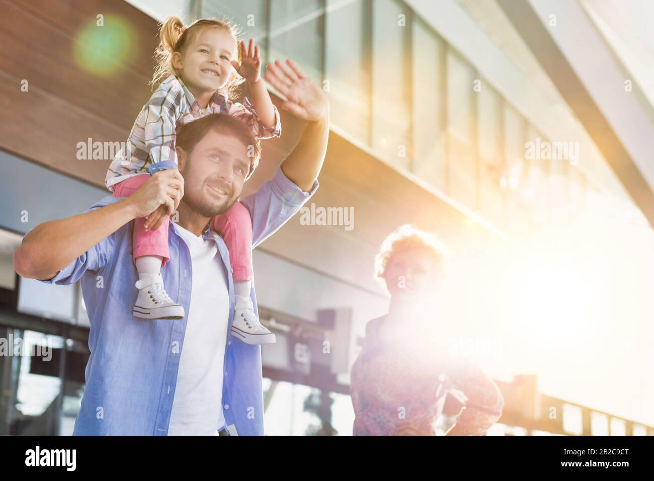 Portrait of one happy family arriving in airport with lens flare Stock ...