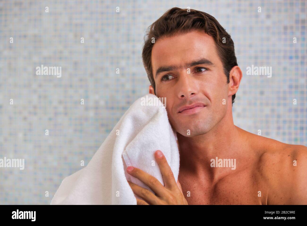 Handsome man wiping towel on his face Stock Photo - Alamy