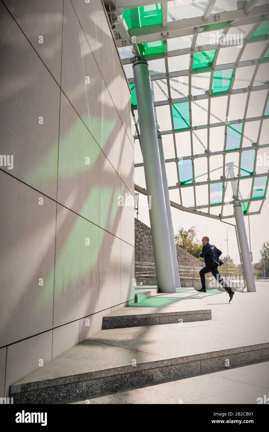 Portrait of businessman running for emergency Stock Photo - Alamy