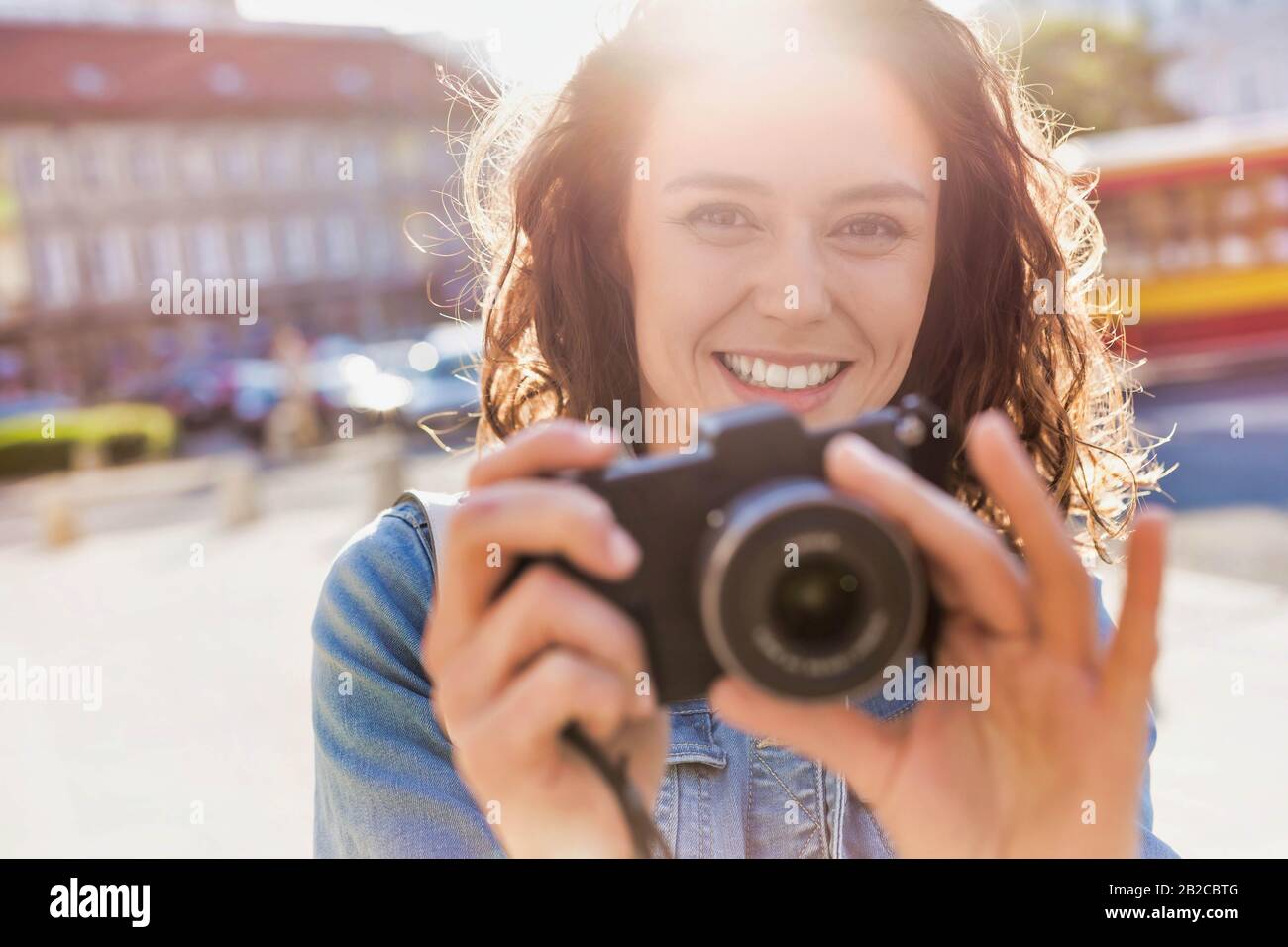 Young attractive woman holding camera and taking photo Stock Photo - Alamy