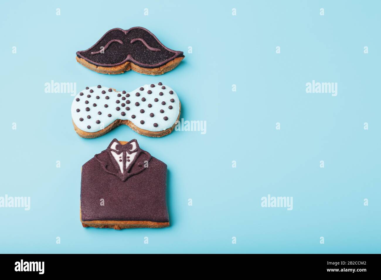 Glazed gingerbread in the form of a mustache, butterfly and tuxedo, men ...