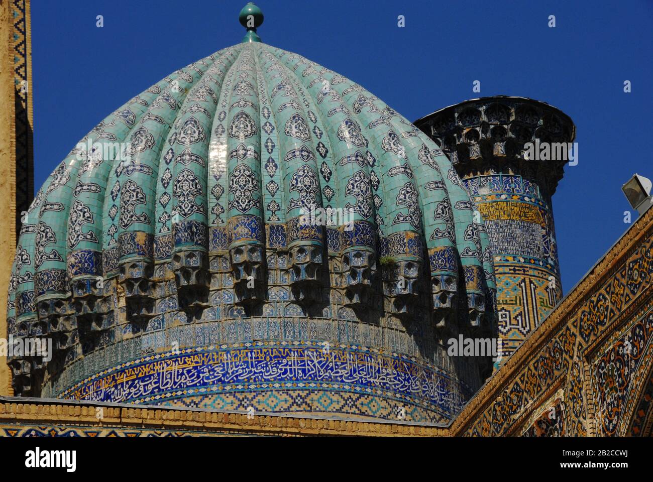 Registan medrese details - bright multicolored dome and minaret against ...
