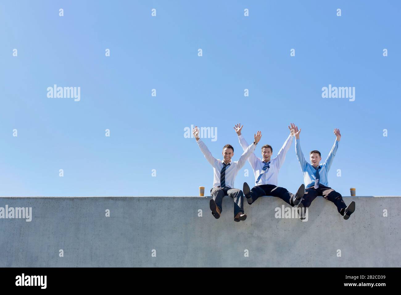 Group of handsome businessmen sitting while having fun in office ...