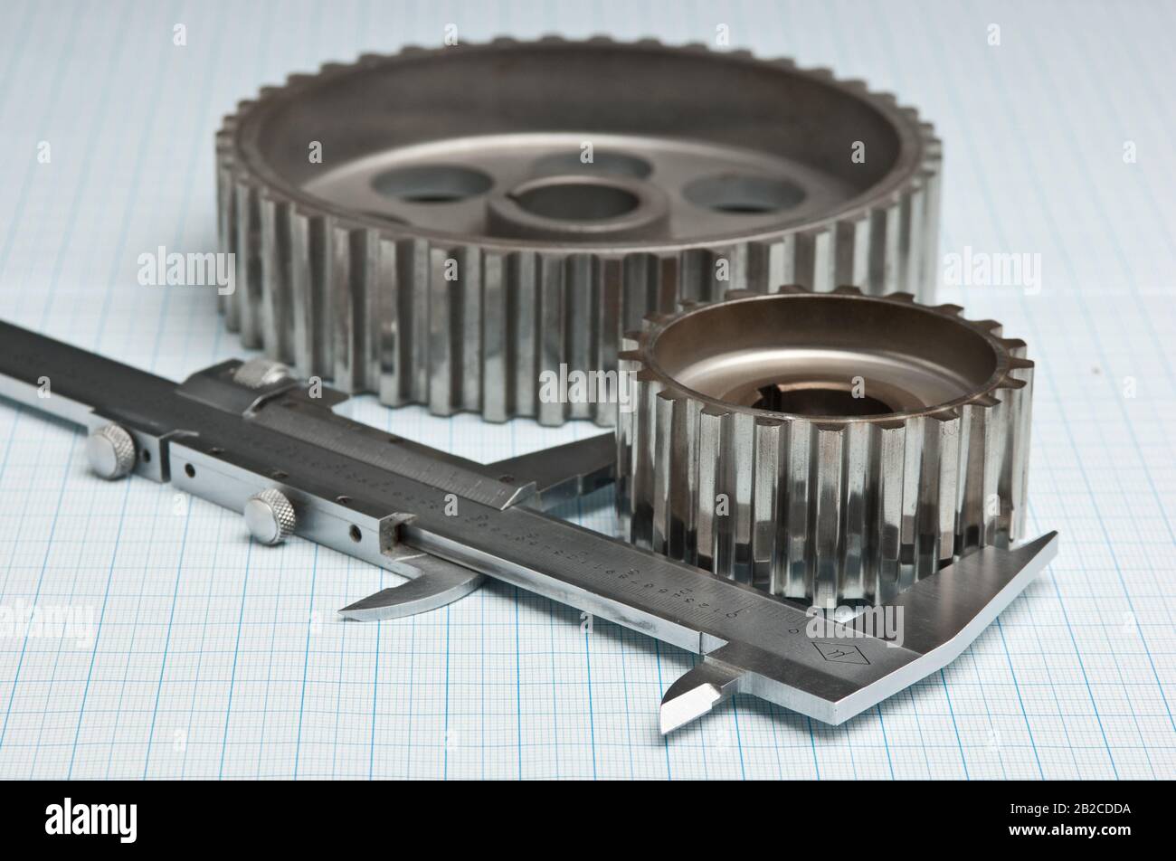 gears and caliper on graph paper Stock Photo - Alamy