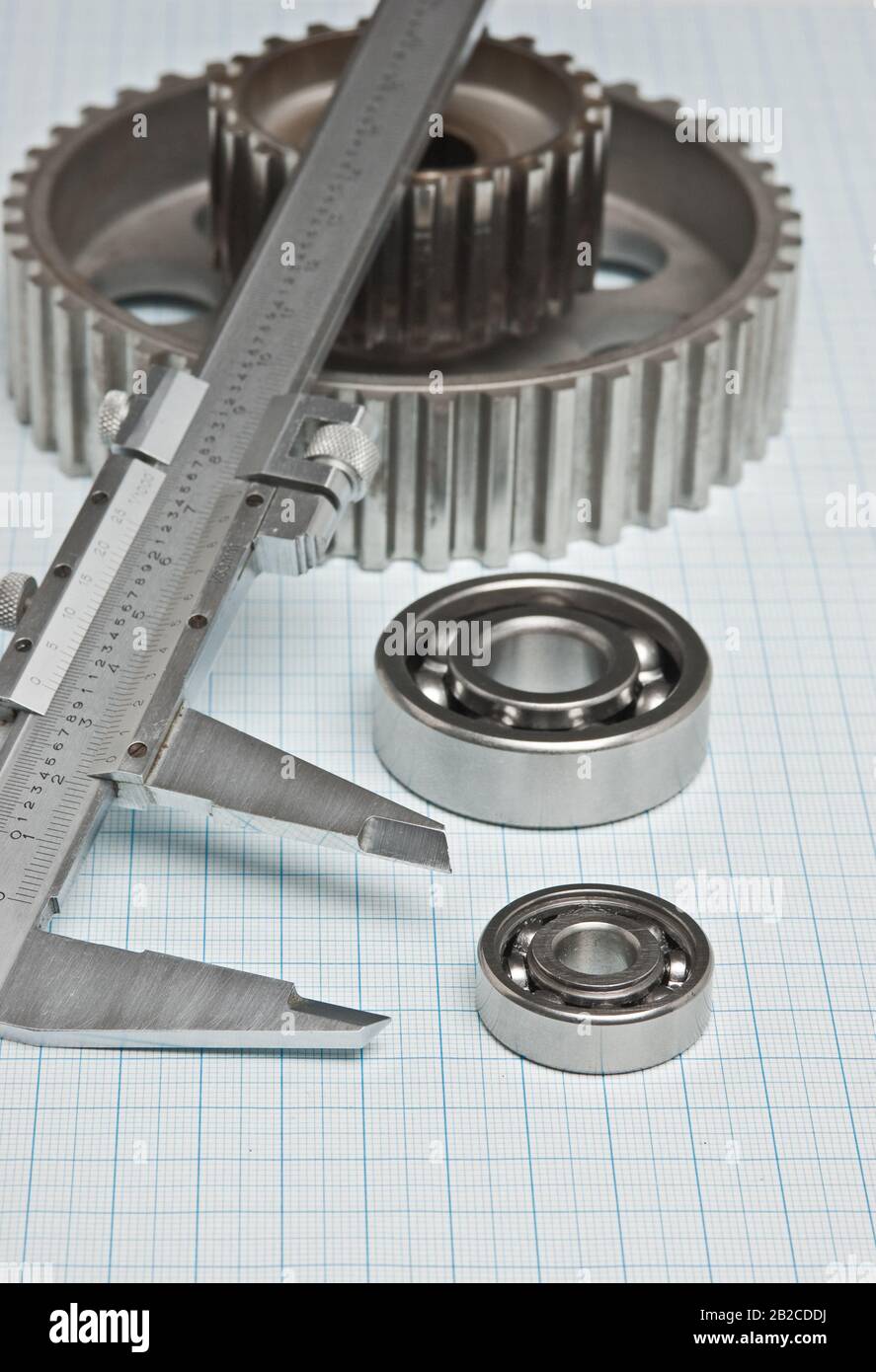 caliper with gears and bearings on graph paper Stock Photo - Alamy