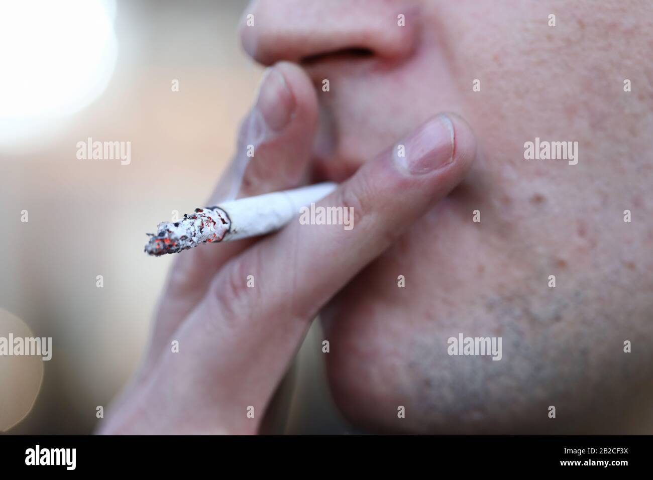 Close up man smoking cigarette, addictive habit Stock Photo - Alamy