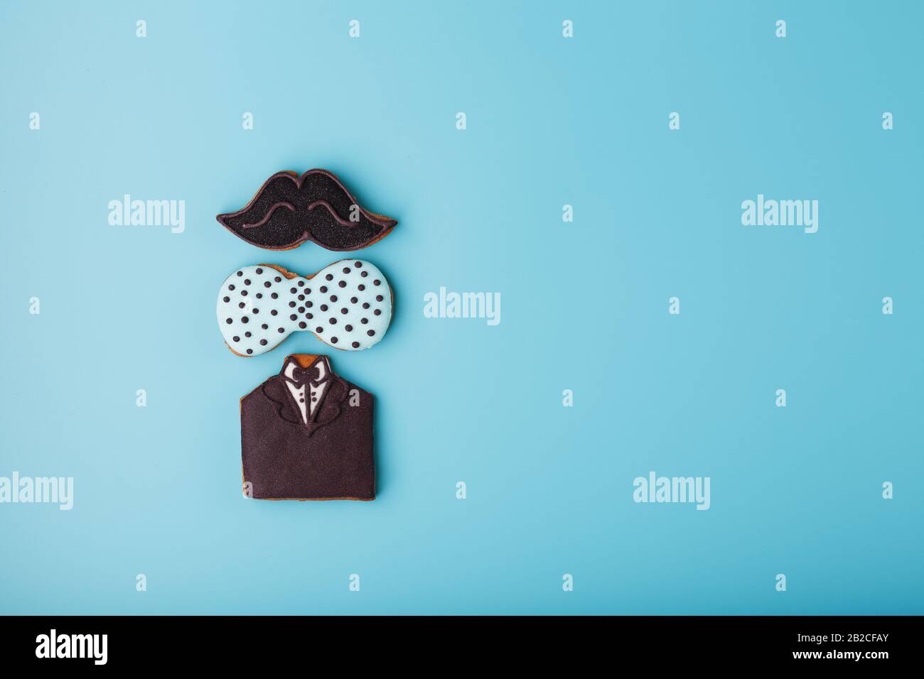 Glazed gingerbread in the form of a mustache, butterfly and tuxedo, men ...