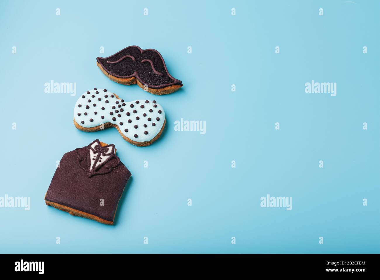 Glazed gingerbread in the form of a mustache, butterfly and tuxedo, men ...