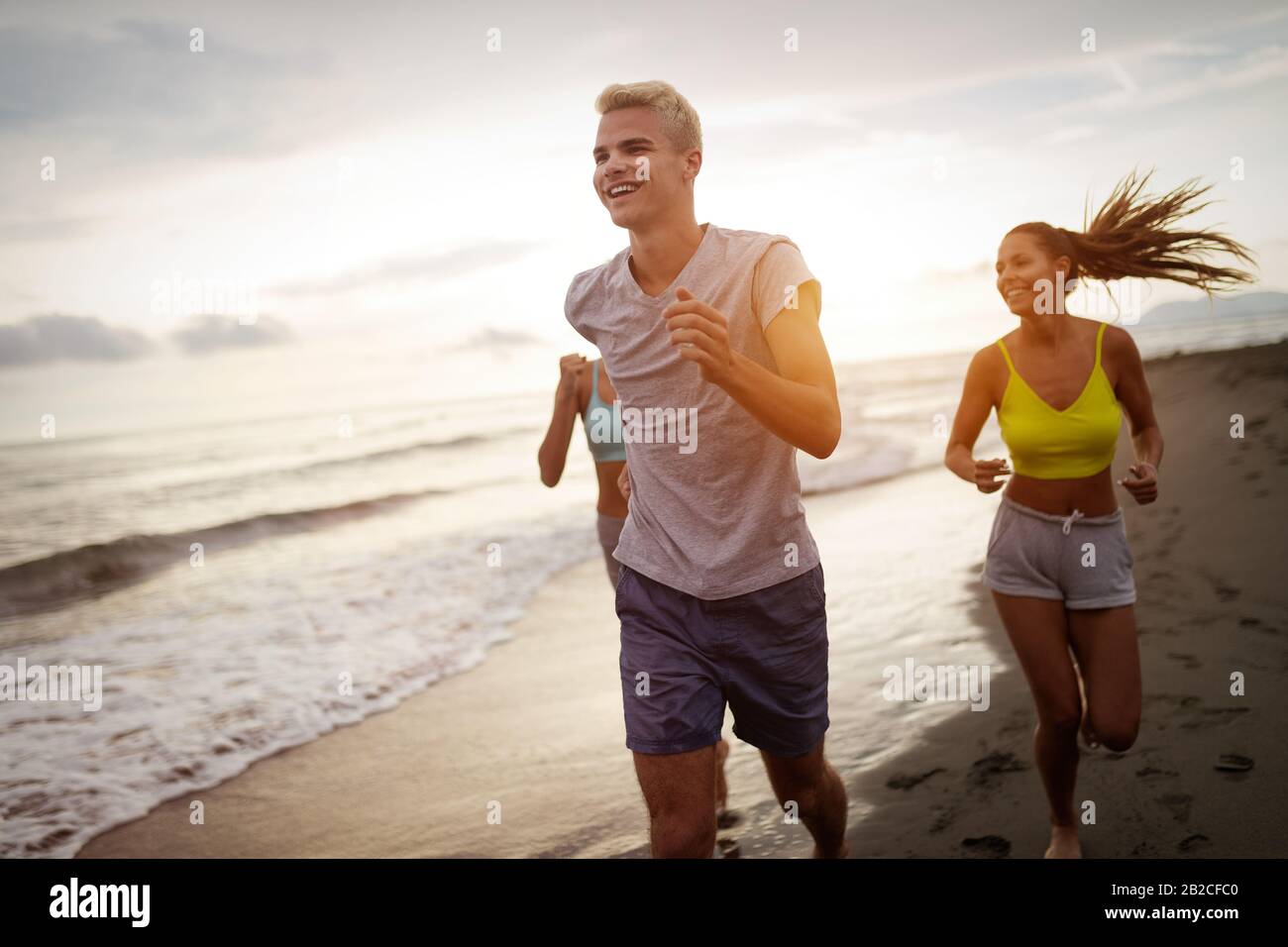 Group Of Friends Running At The Beach High Resolution Stock Photography ...