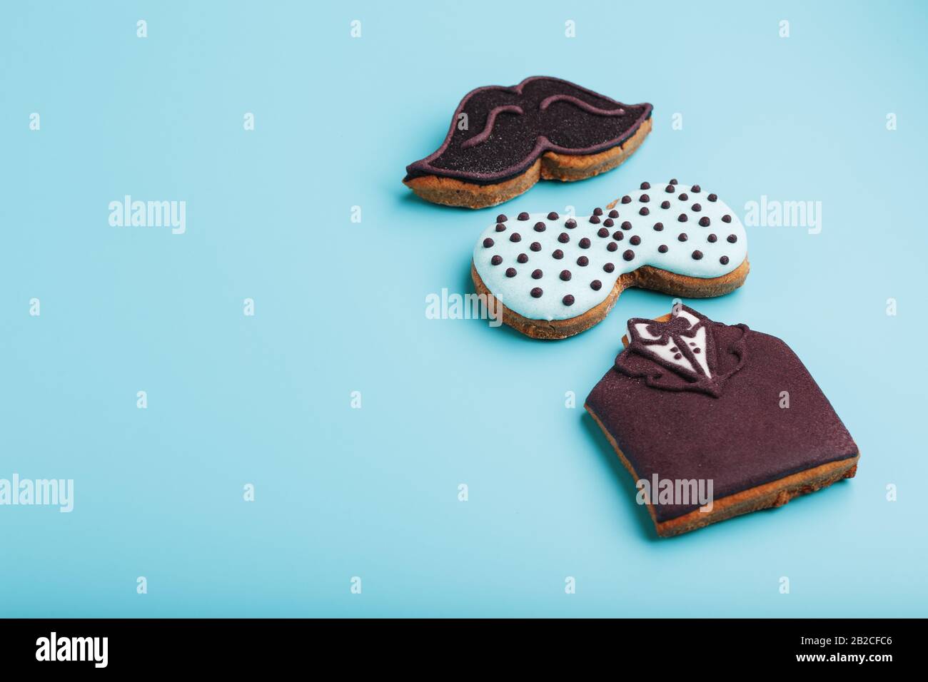 Glazed gingerbread in the form of a mustache, butterfly and tuxedo, men ...