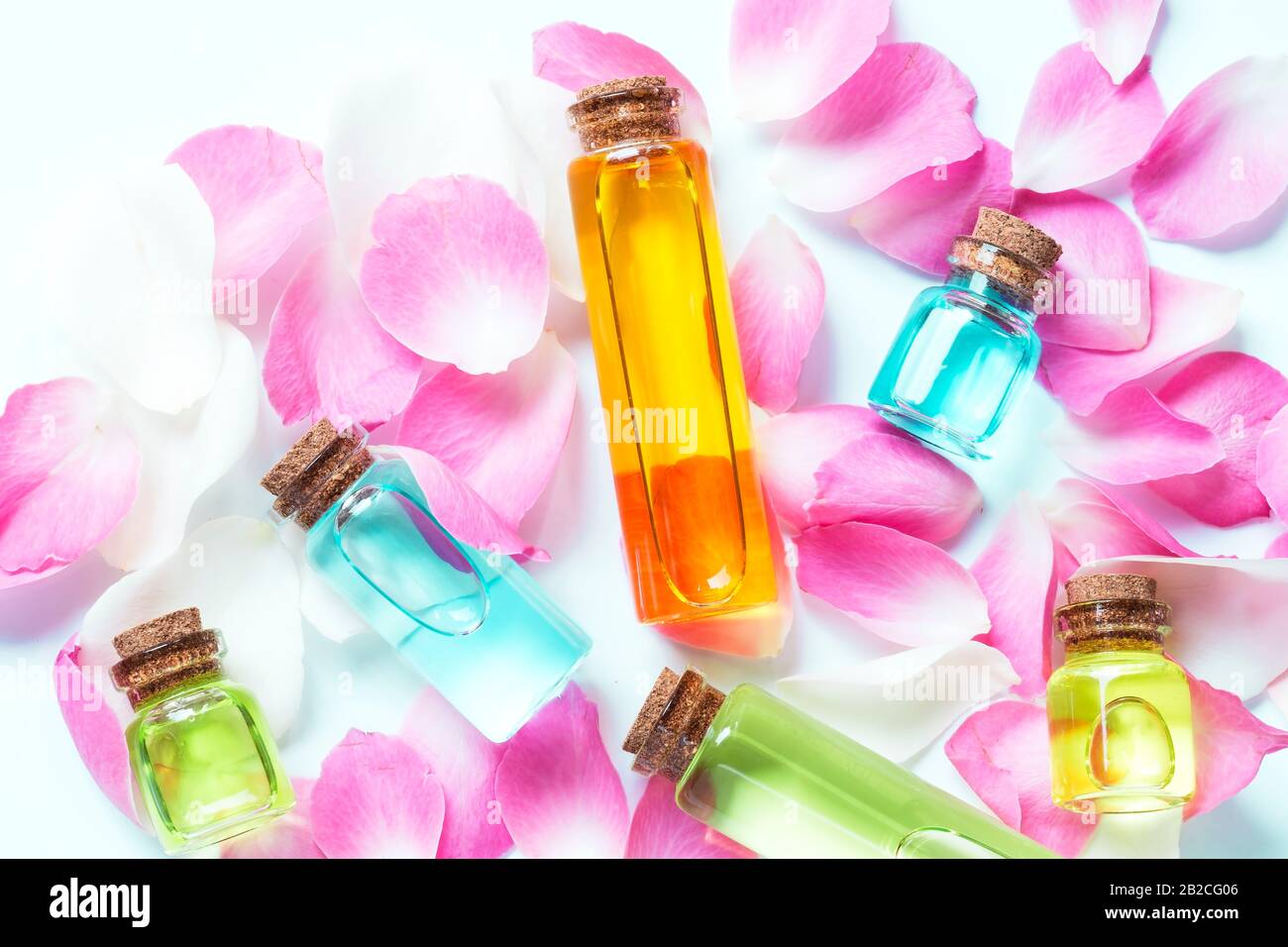 Essence oil bottles with pink rose petals Stock Photo - Alamy