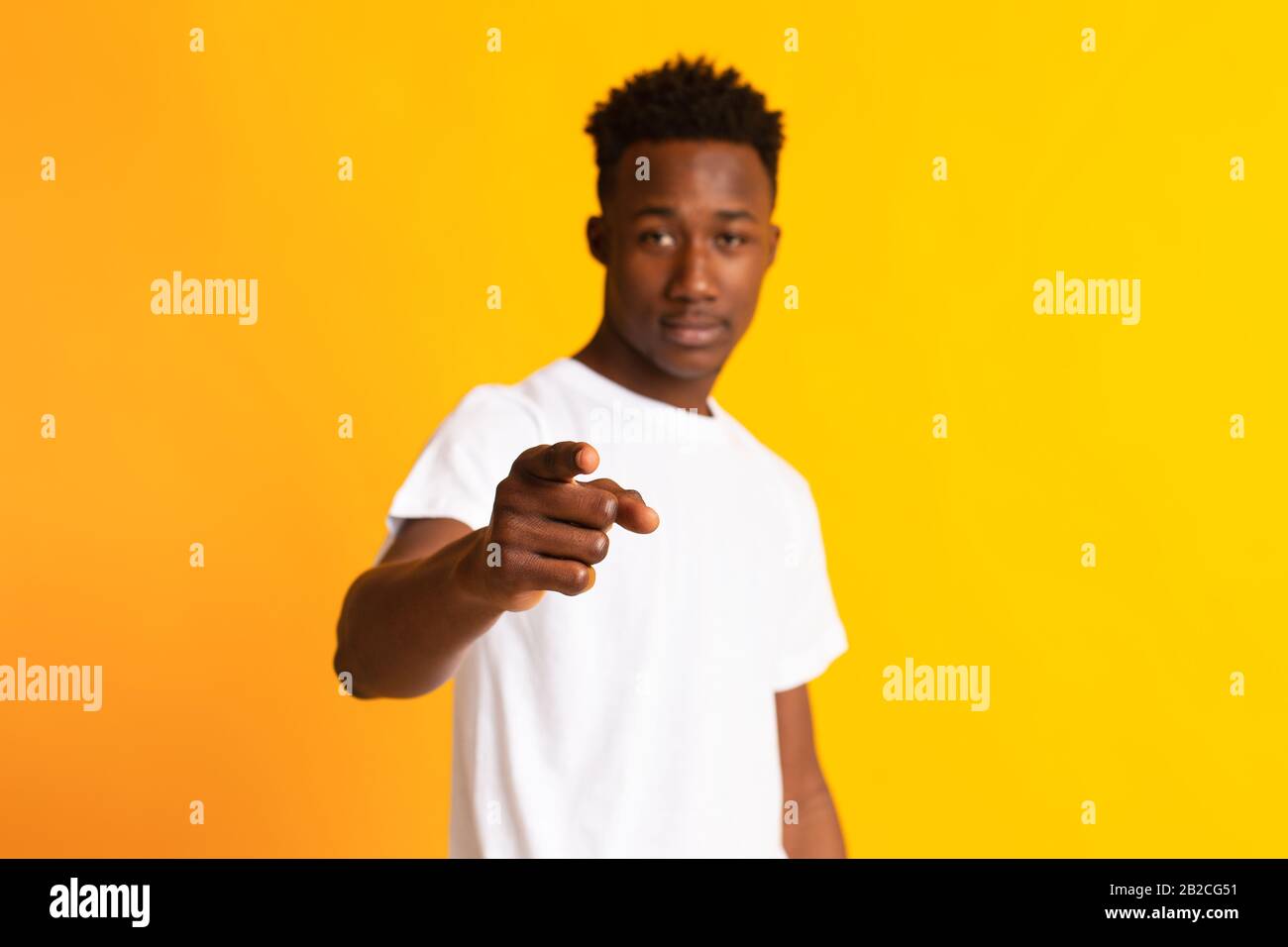 Serious millennial man pointing hi-res stock photography and images - Alamy