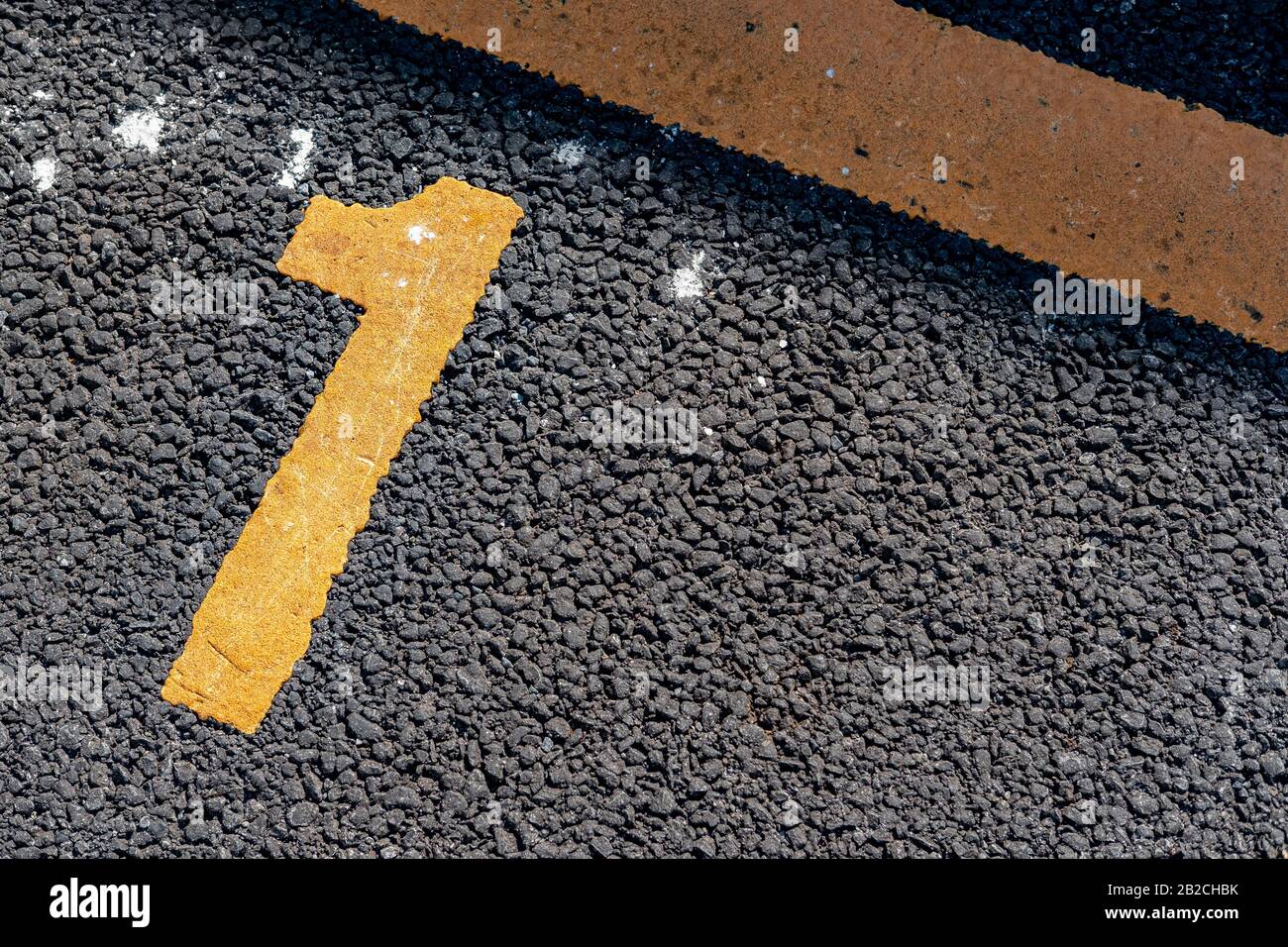 Asphalt parking lot with yellow lot line and yellow lot number 1 Stock ...