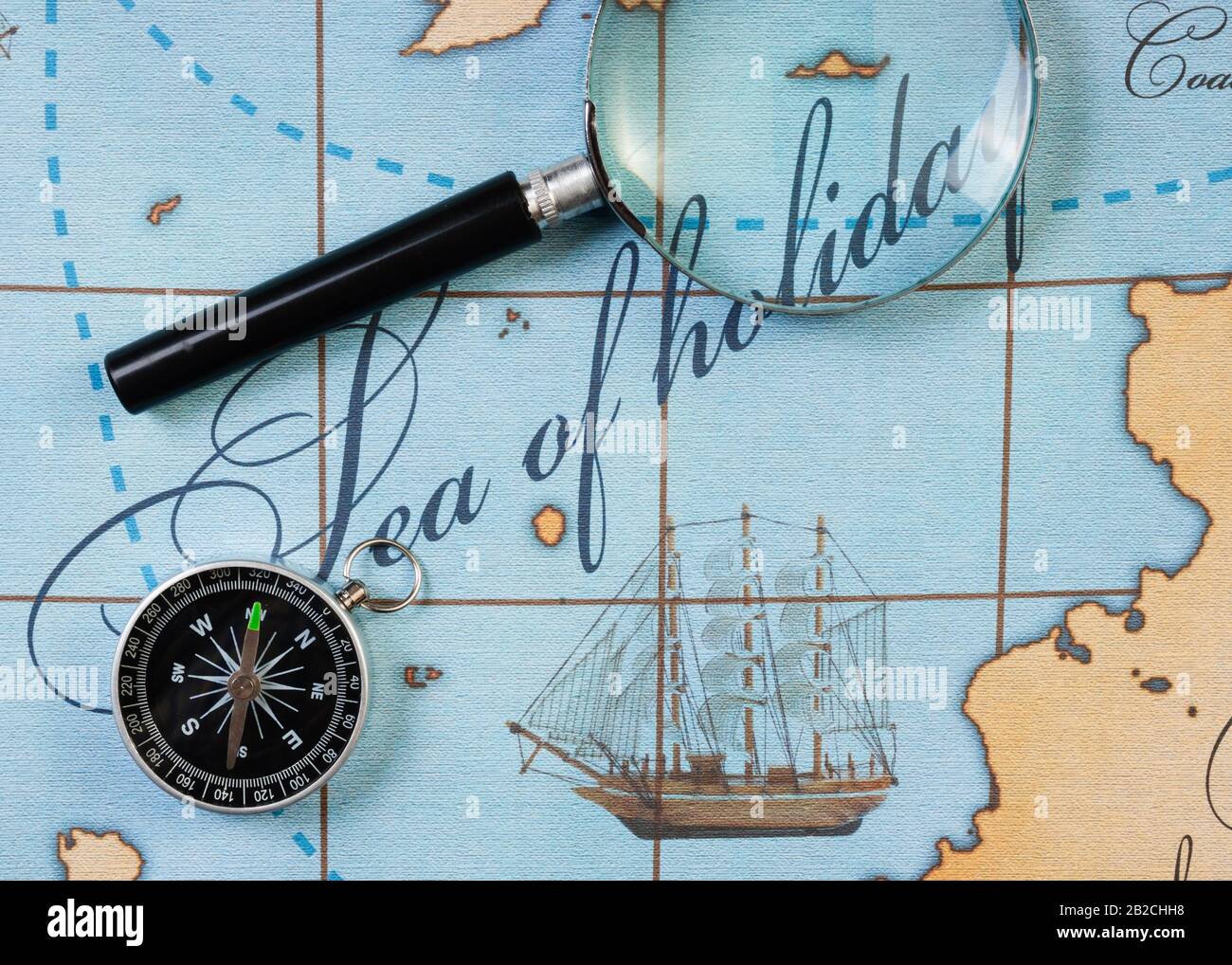 magnifier and compass on a stylized map Stock Photo - Alamy